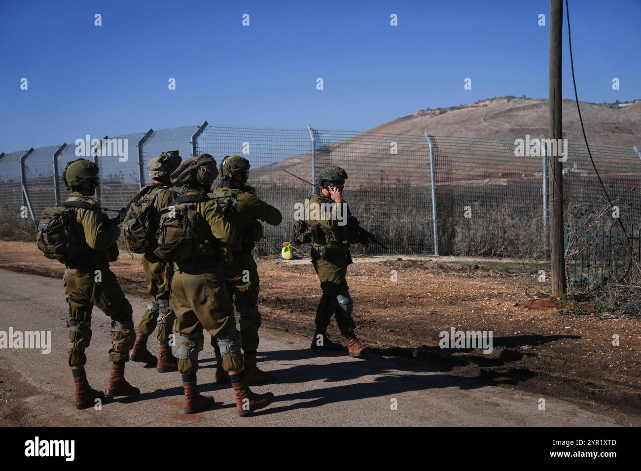 Israeli soldiers patrol the perimeter of the agricultural settlement of ...