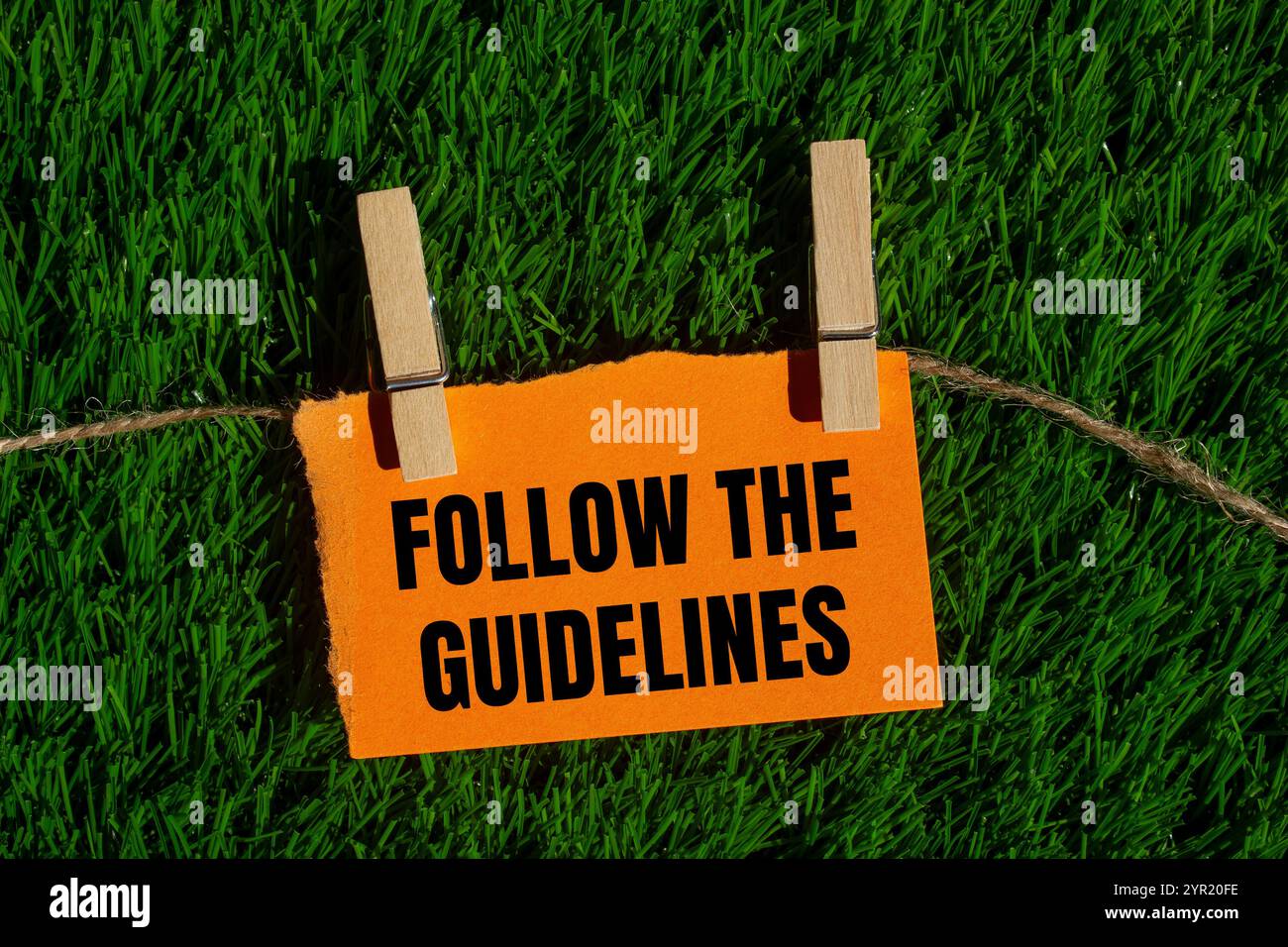 Follow the guidelines message written on ripped torn orange paper piece ...