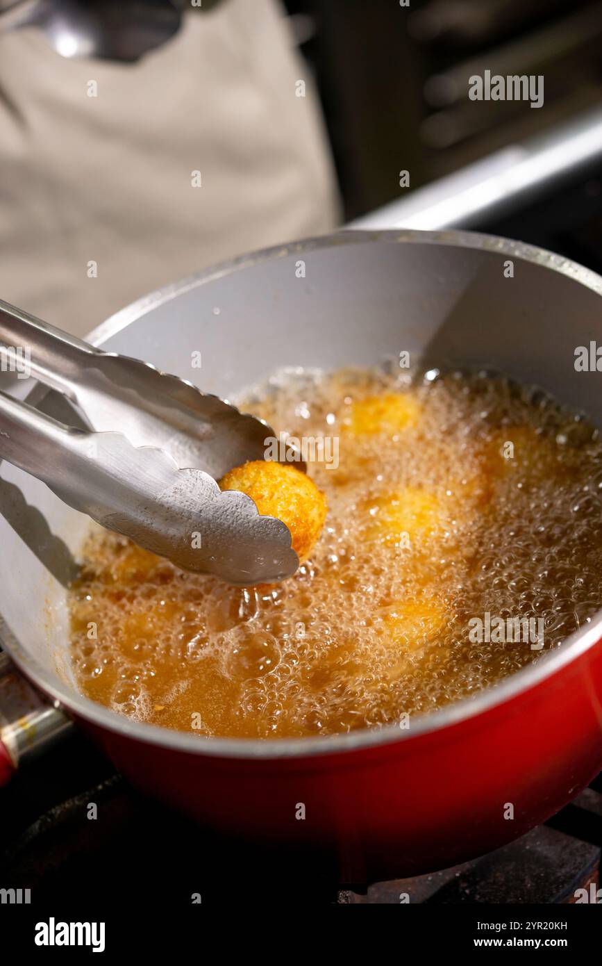 hands frying cheese balls in a pan with boiling oil Stock Photo - Alamy