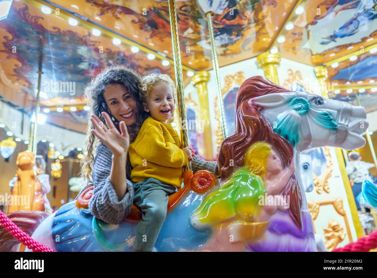 Woman riding carousel horse hi-res stock photography and images - Alamy
