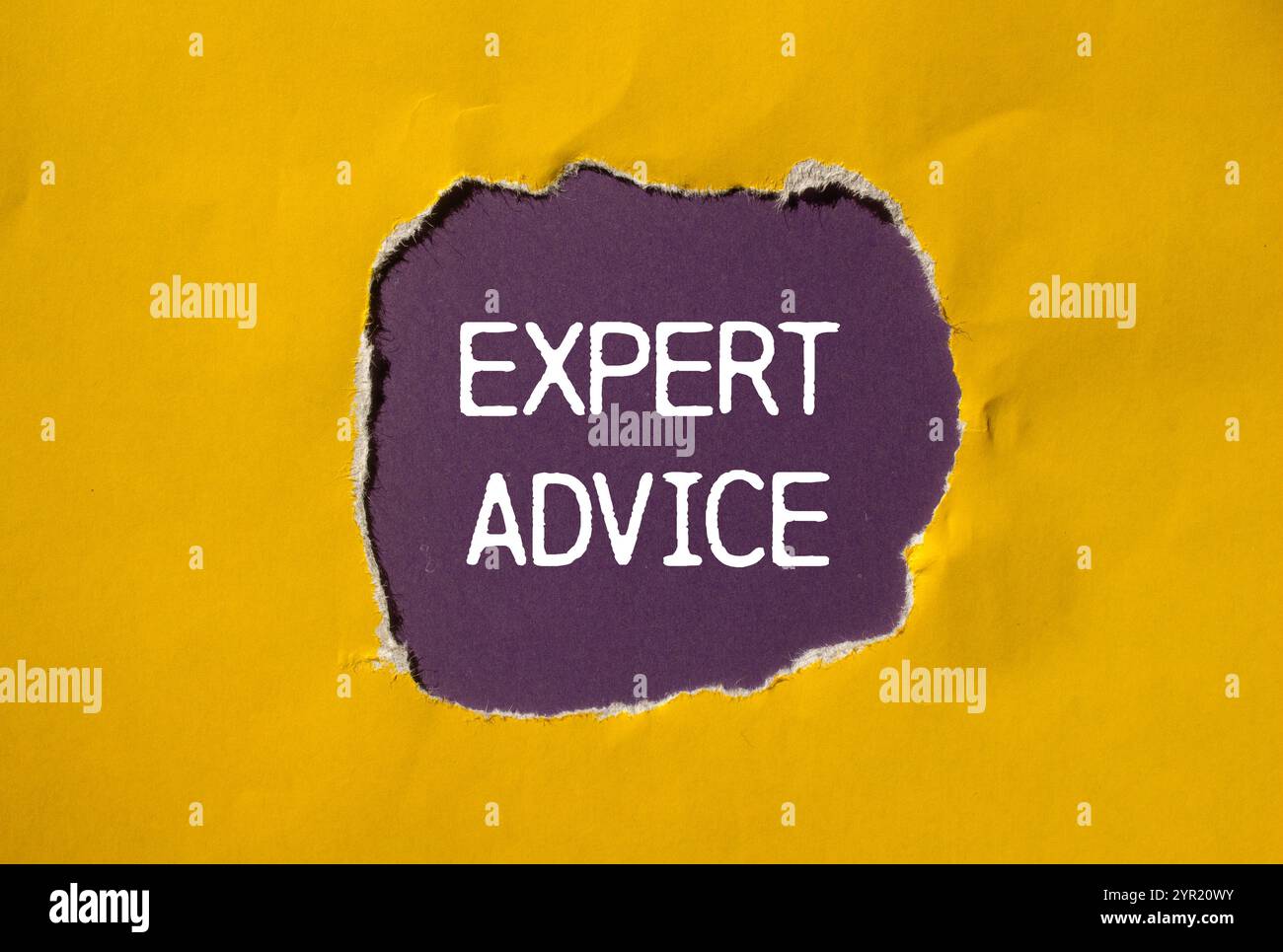 Expert advice message written on ripped torn yellow paper with purple ...