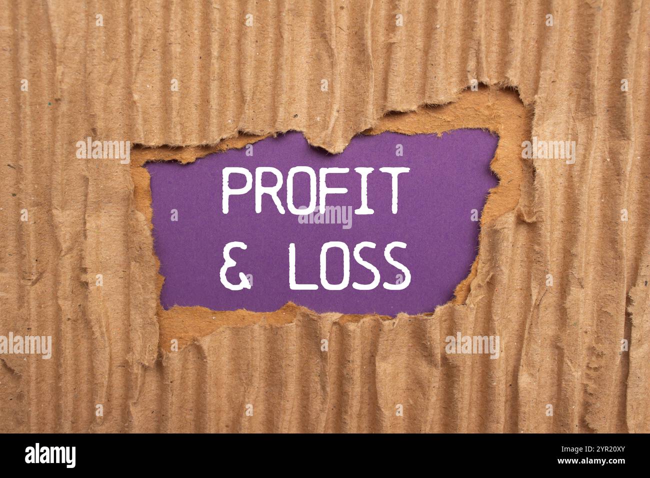 Profit and loss message written on ripped torn cardboard paper with ...