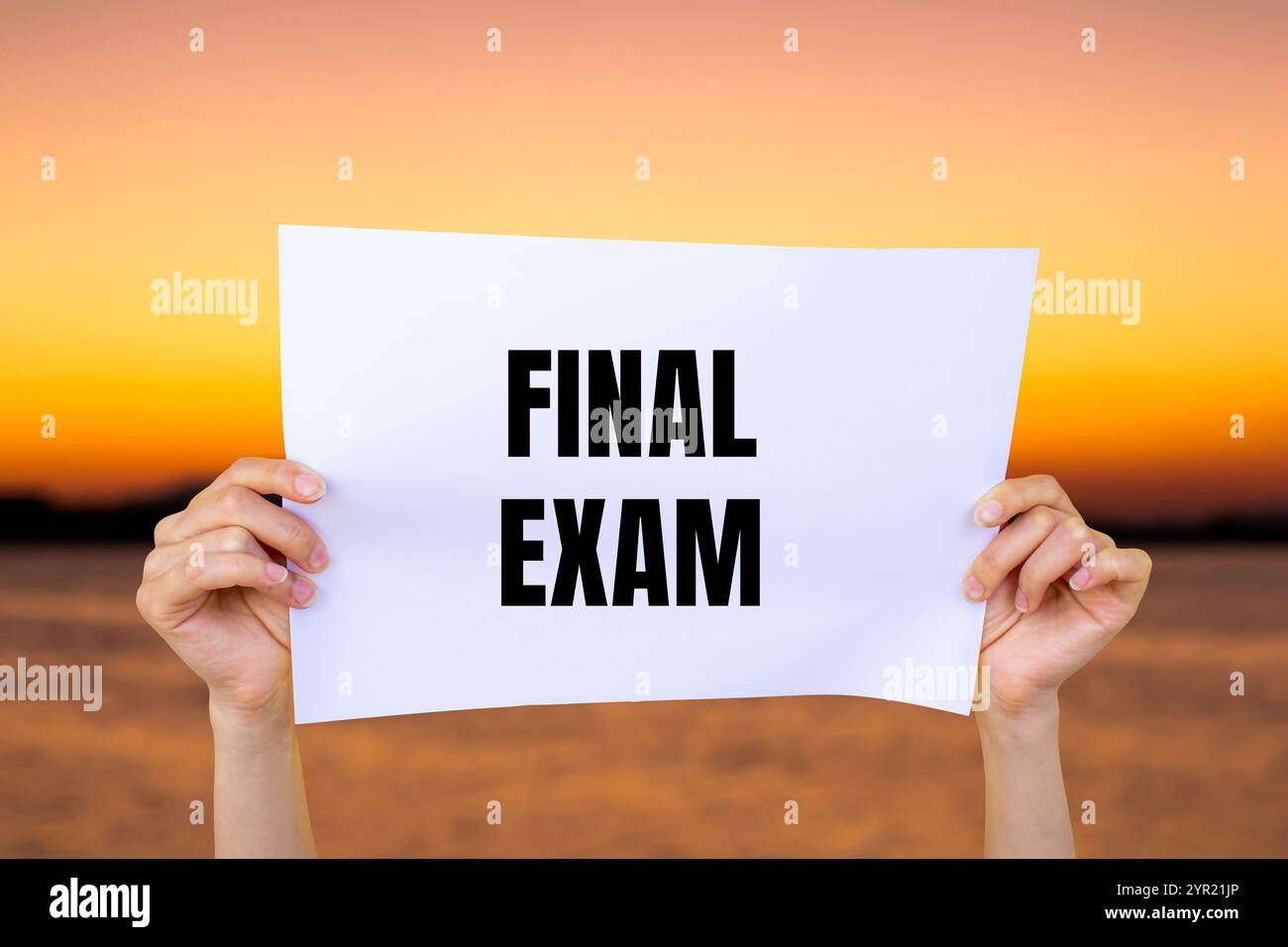 Final exam message written on white paper with blurry lake background ...