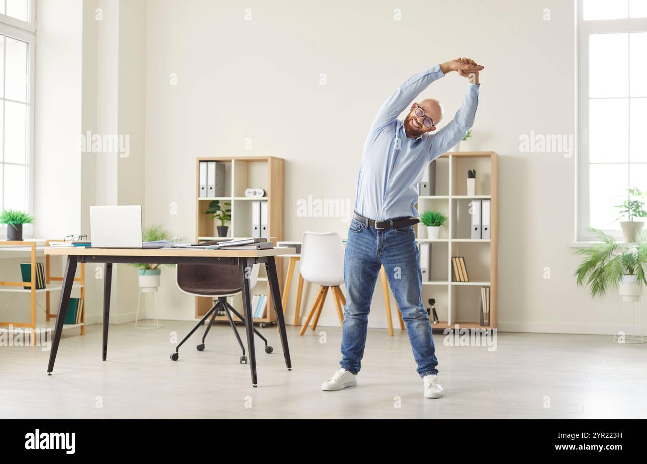 Active office worker stretching, relaxing after sitting long in ...