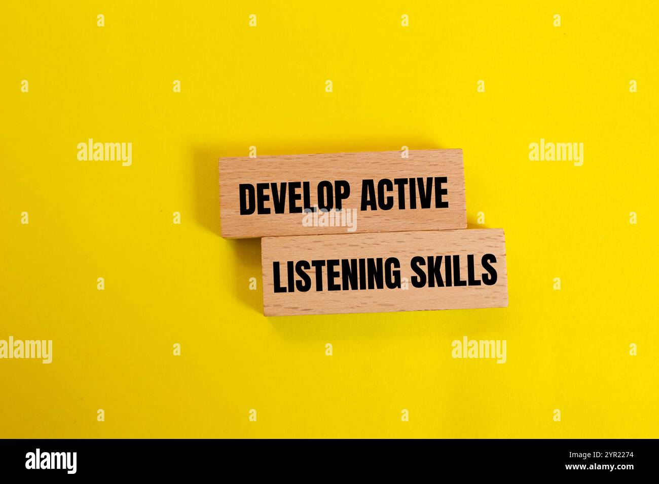 Develop active listening skills message written on wooden blocks with ...
