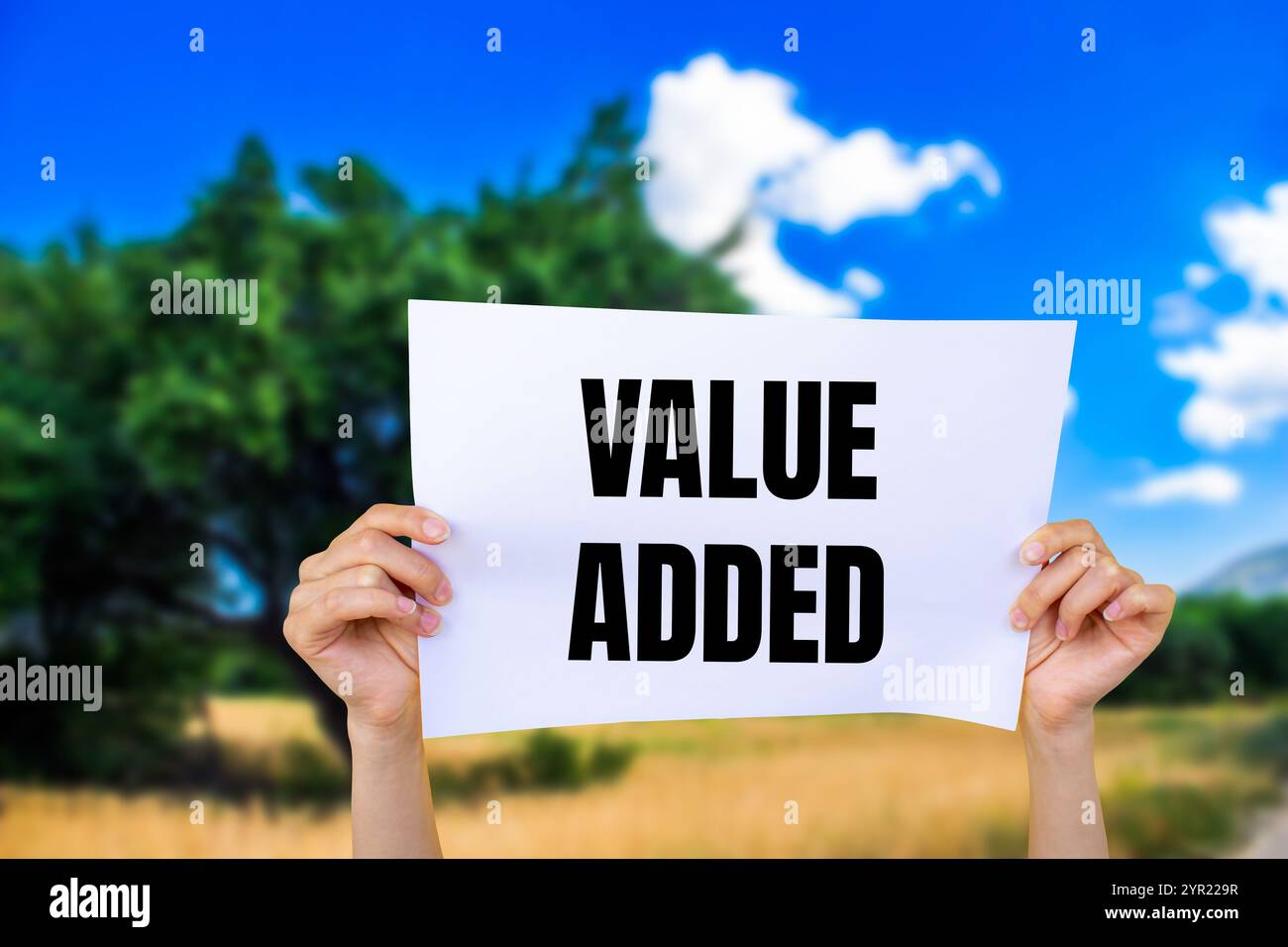Value added message written on white paper with nature background ...