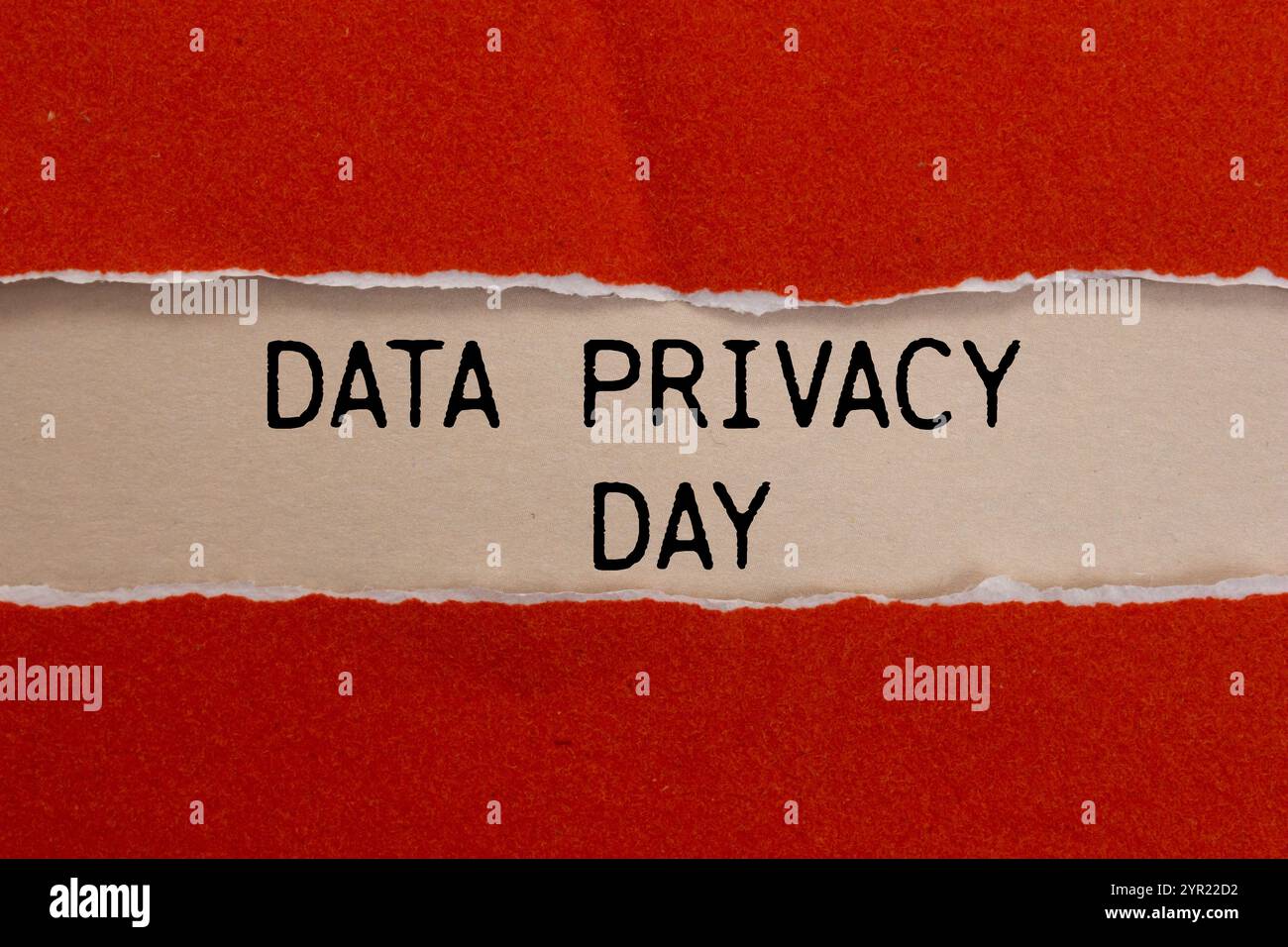 Data privacy day message written on ripped torn red paper with beige ...