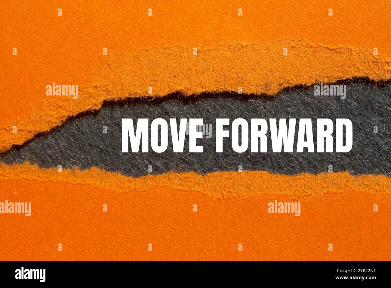 Move forward message written on ripped torn orange paper with gray background. Conceptual move ...