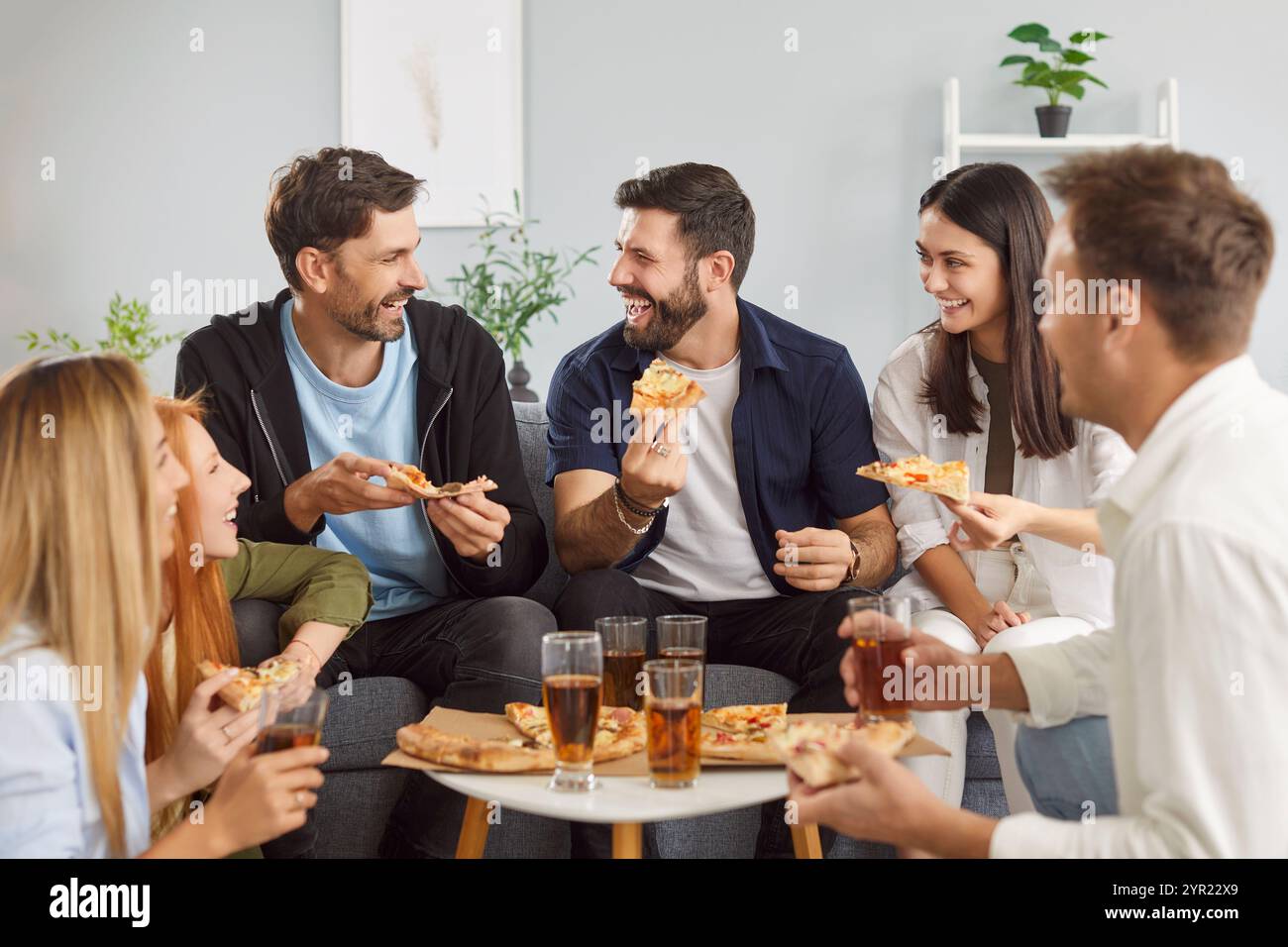 Young company friends eating pizza hi-res stock photography and images ...