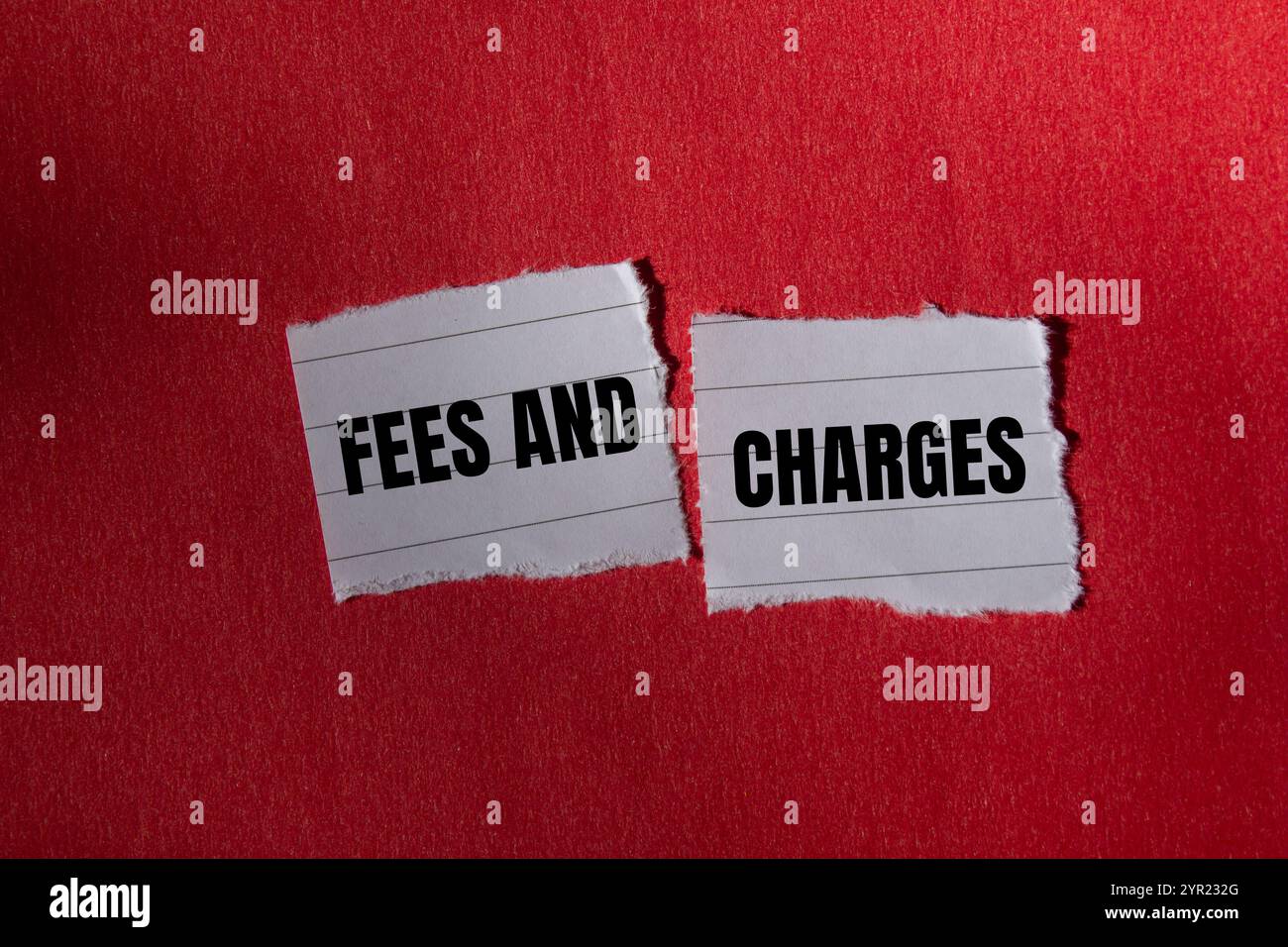 Fees and charges message written on ripped torn paper piece with red ...