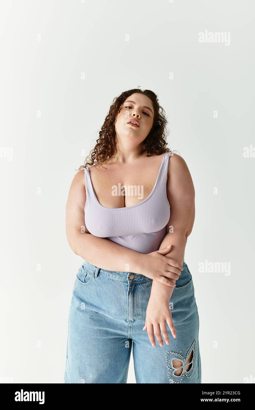 Confident woman showcases a fashionable outfit while striking a bold ...