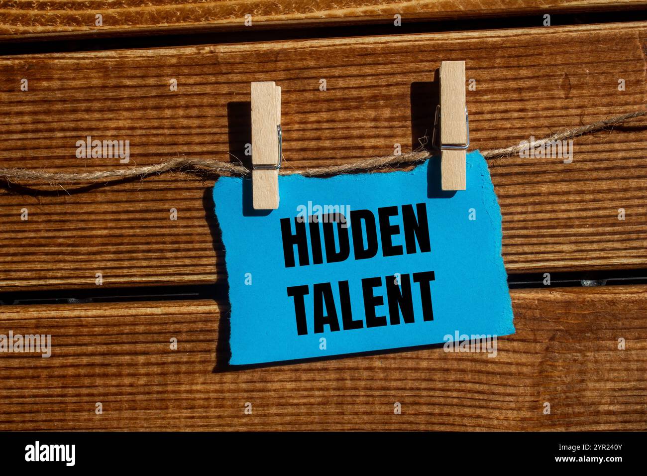 Hidden talent message written on ripped blue torn paper piece with ...