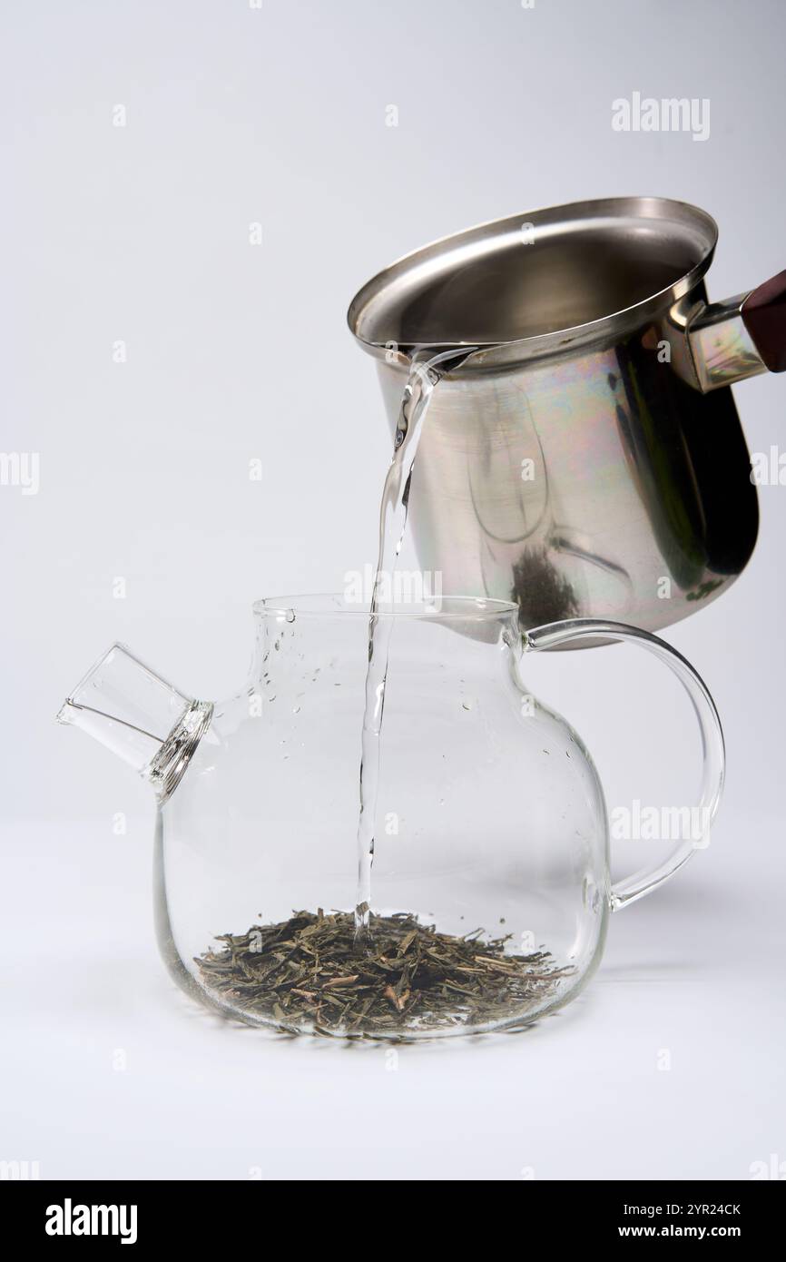 Making of Japanese Sencha tea isolated on white background, pouring hot ...