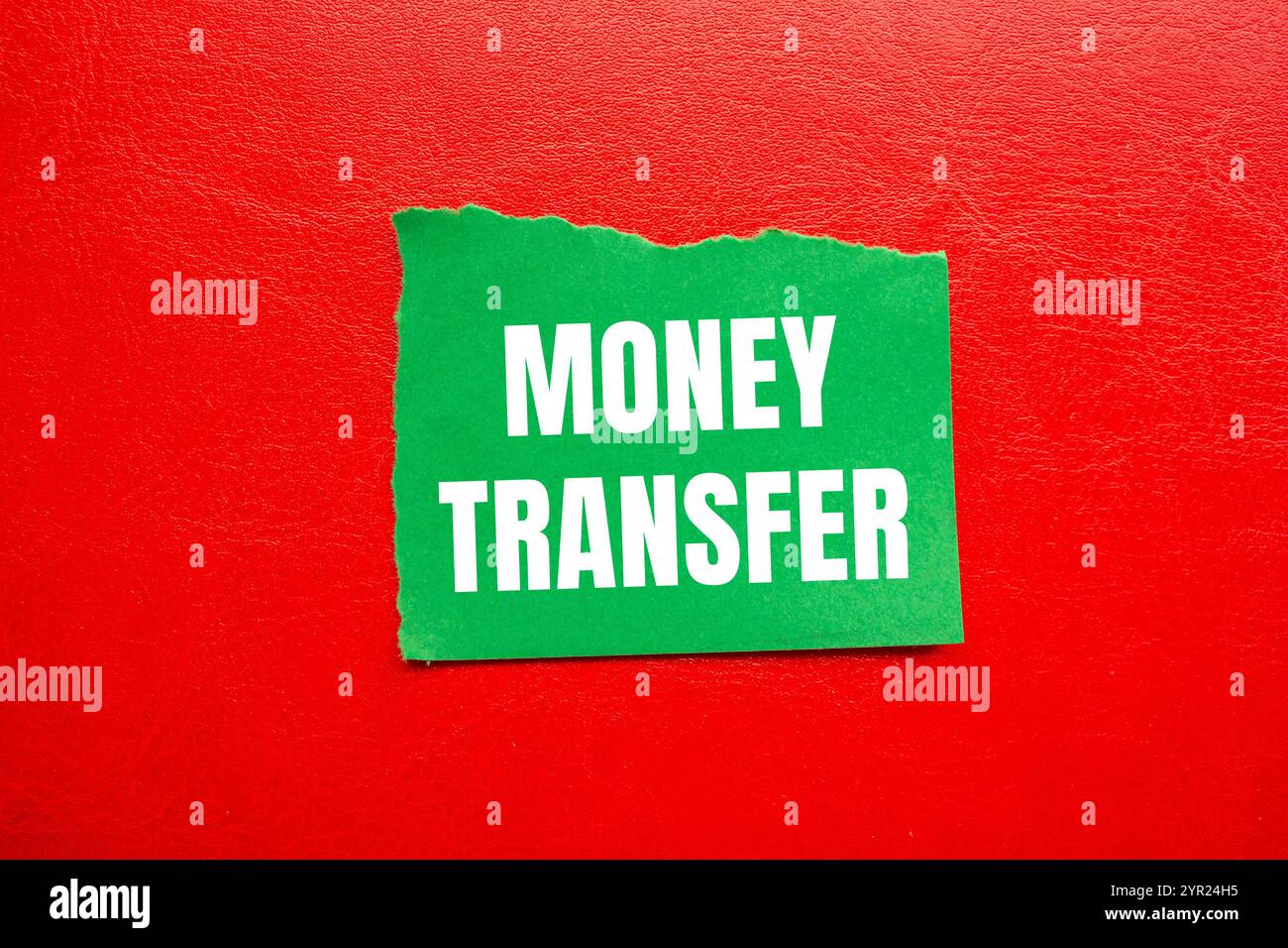 Money transfer message written on ripped torn green paper piece with ...