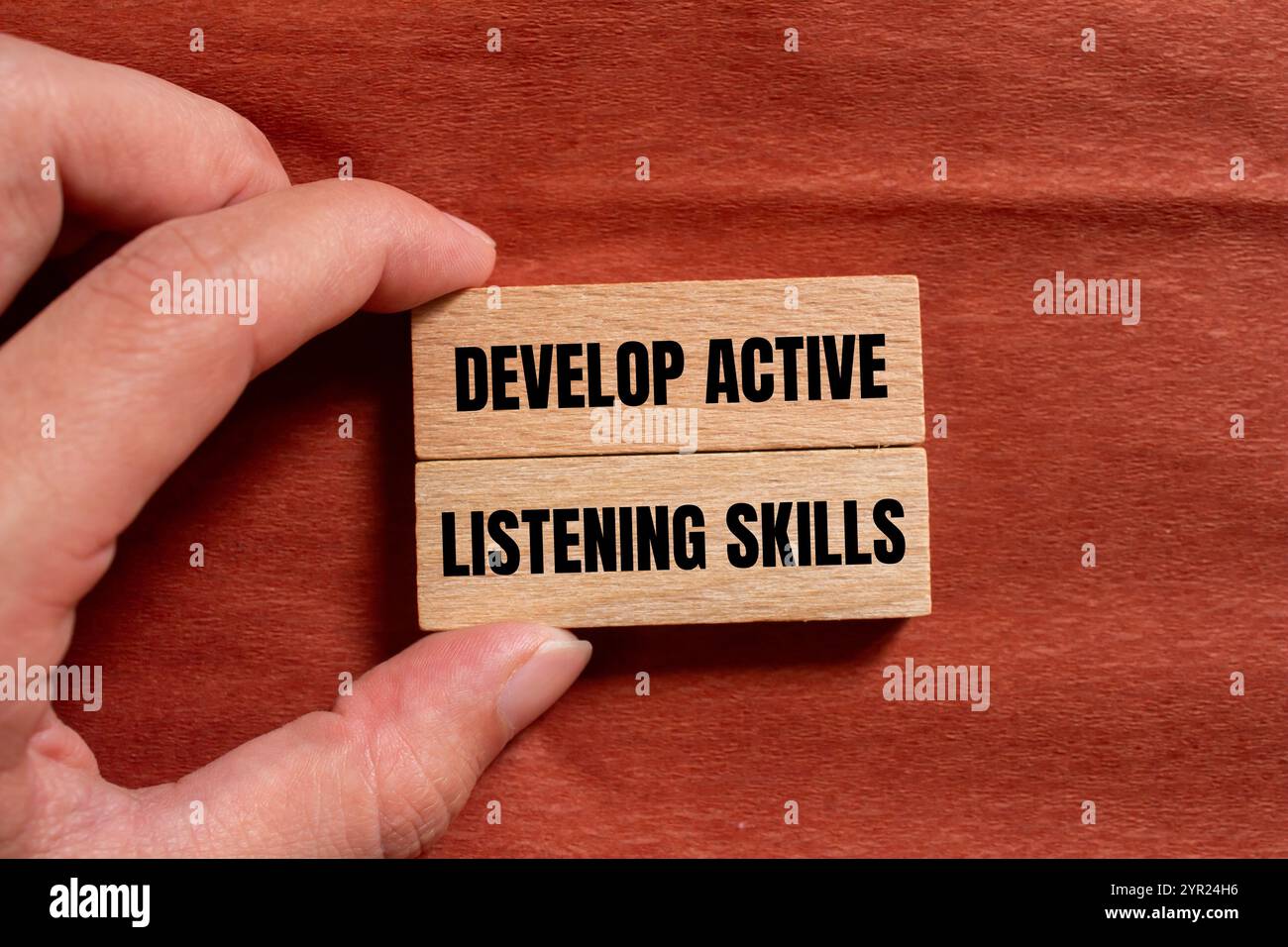 Develop active listening skills message written on wooden blocks with ...