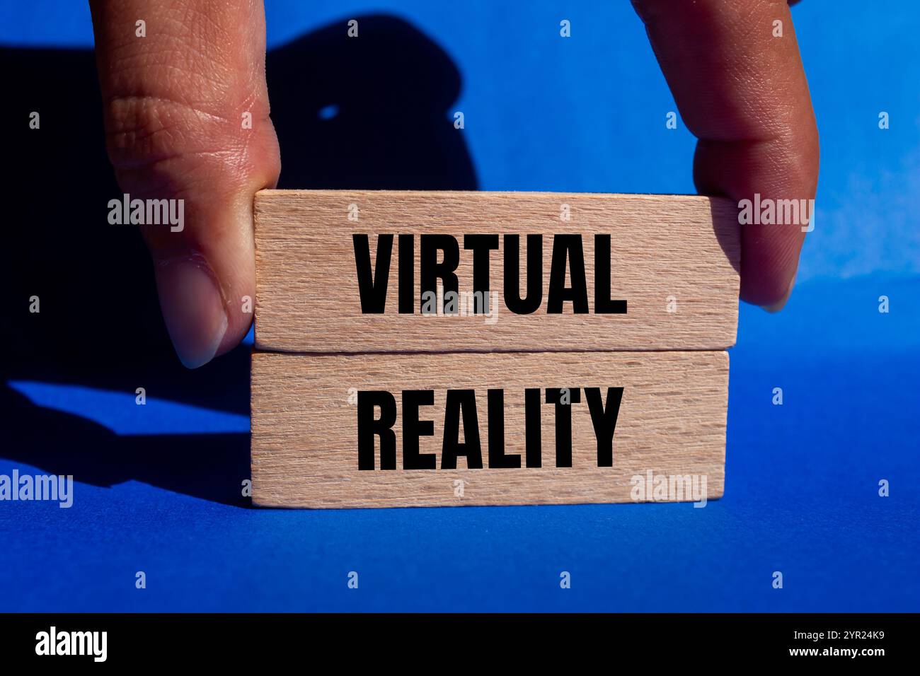 Virtual reality message written on wooden blocks with blue background ...