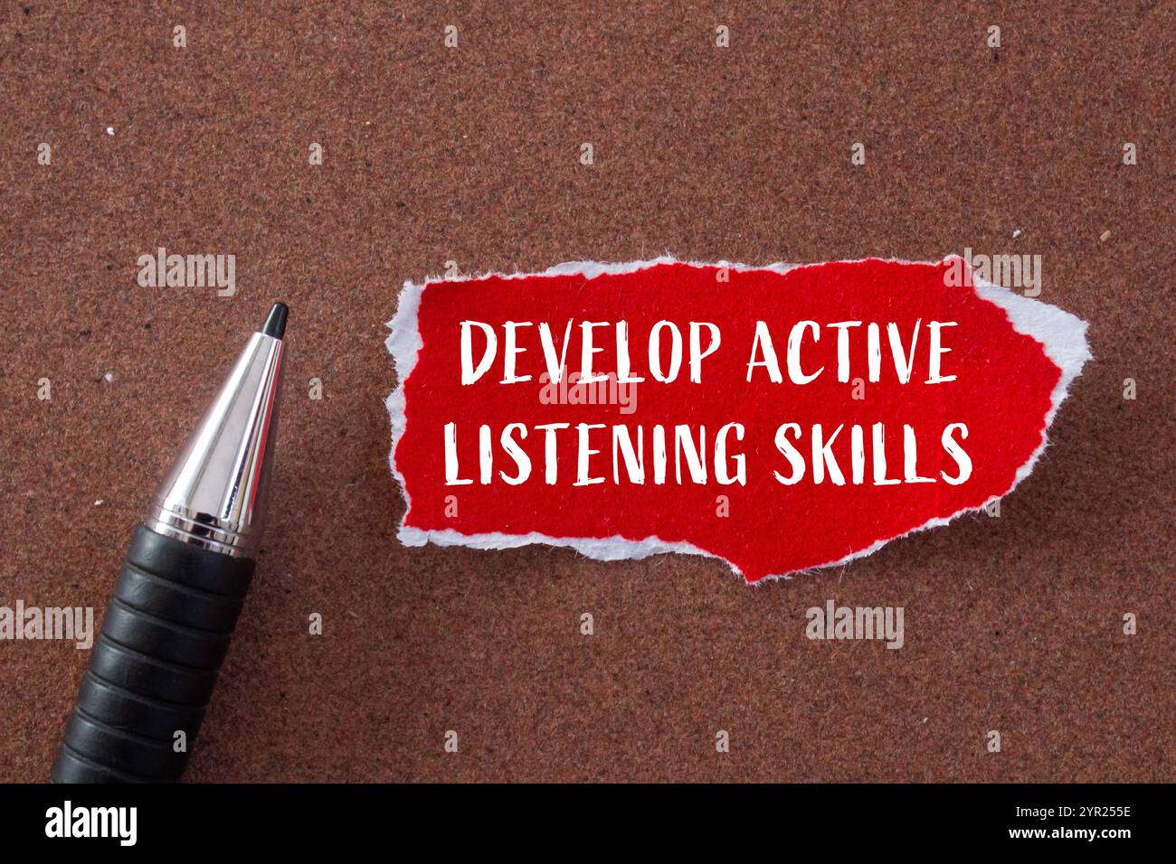 Develop active listening skills message written on ripped torn red ...