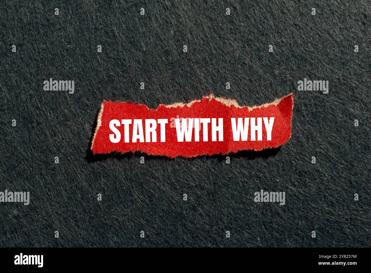 Start with why message written on ripped torn red paper piece with gray background. Conceptual ...