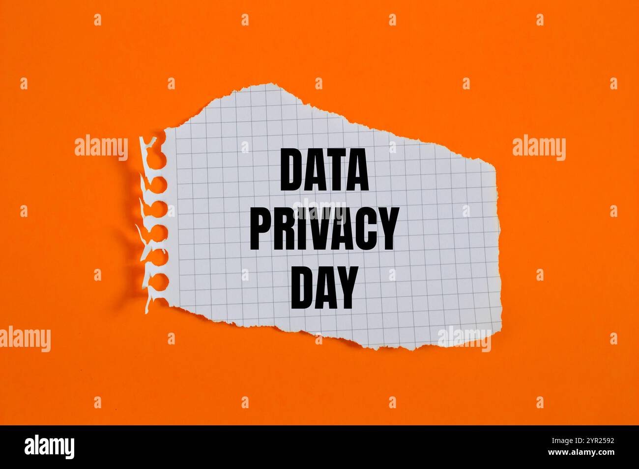 Data privacy day message written on ripped torn checkered graph paper ...