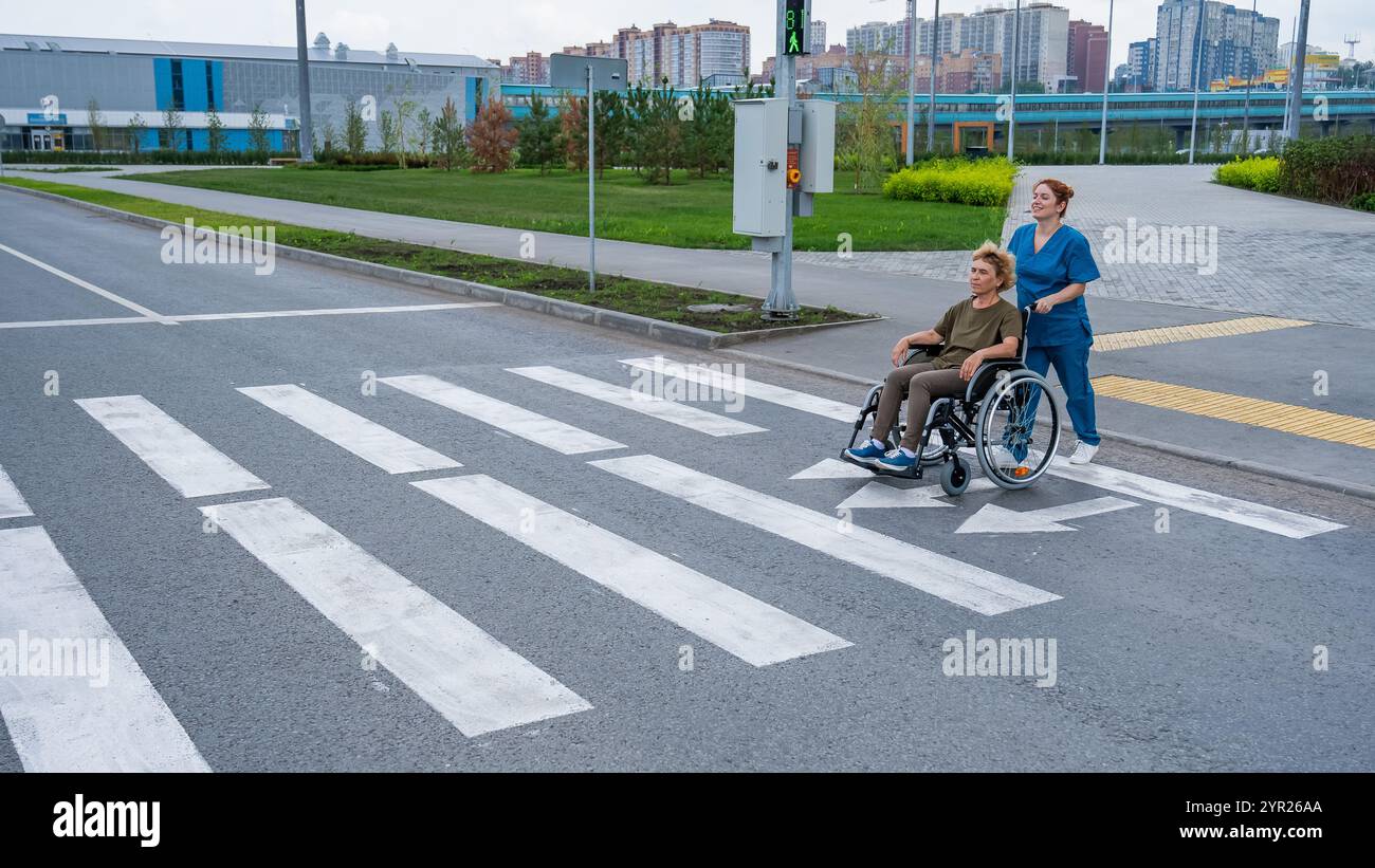 Helping elderly cross street hi-res stock photography and images - Alamy