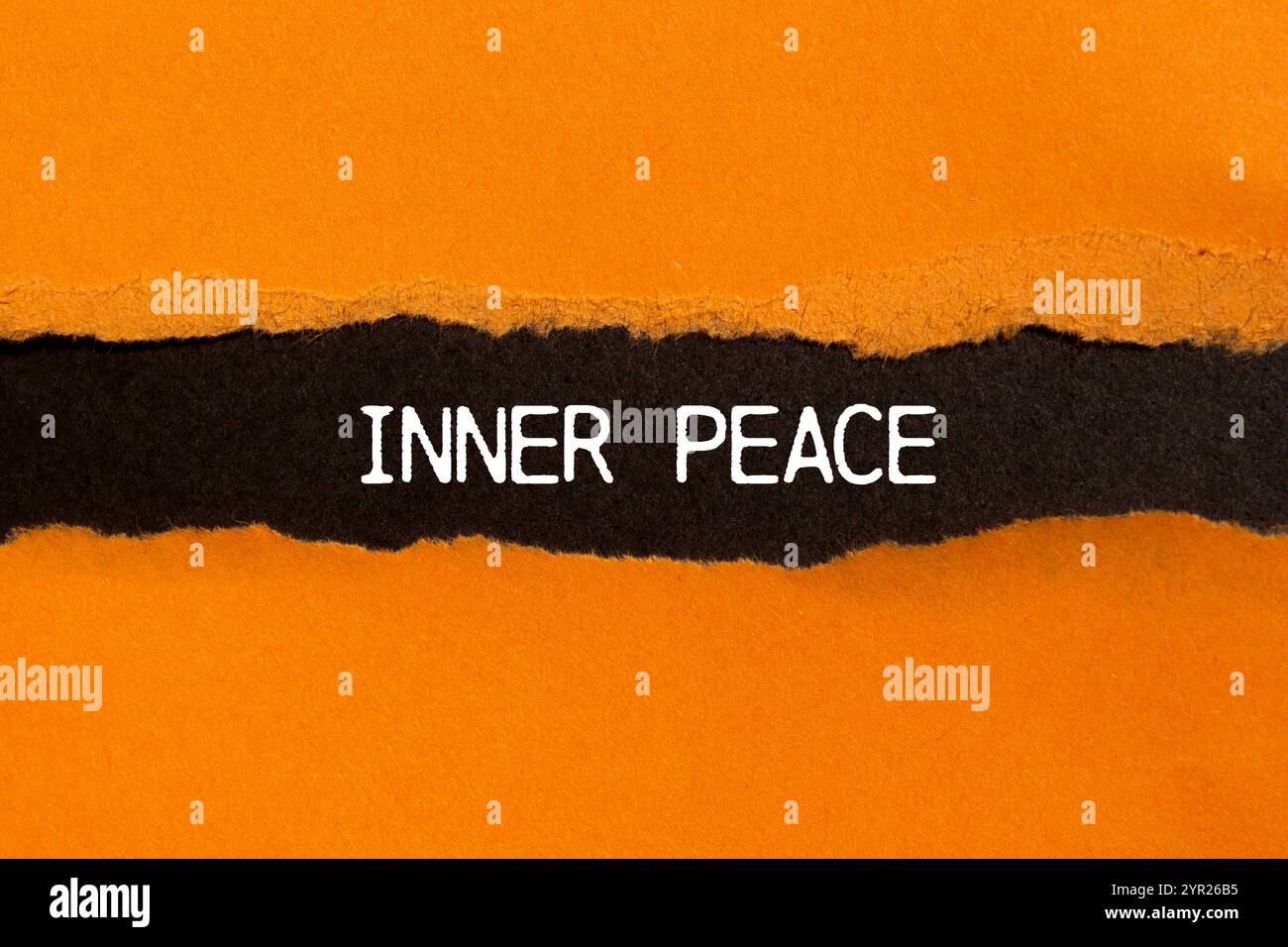 Inner peace message written on ripped torn orange paper with black ...