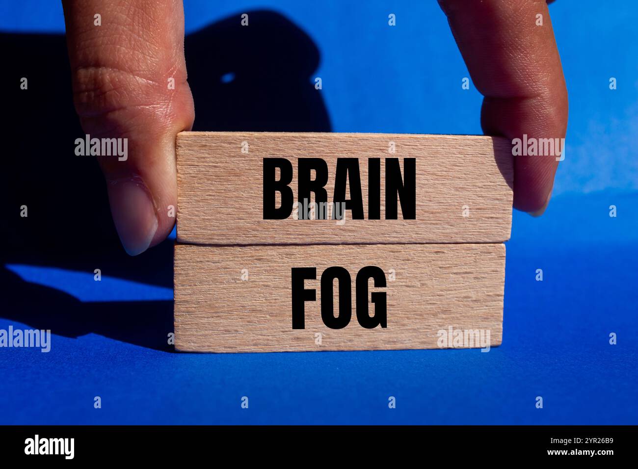 Brain fog message written on wooden blocks with blue background ...
