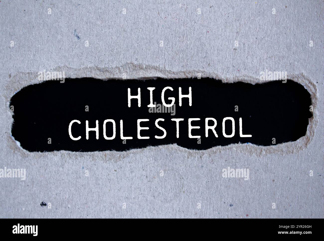 High cholesterol message written on ripped torn gray paper with black ...