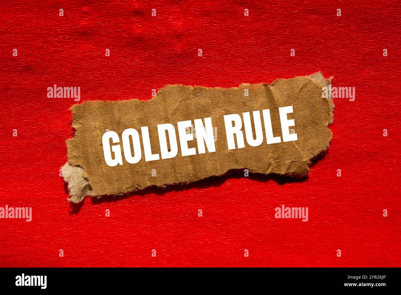 Golden rule message written on ripped torn cardbaord paper piece with ...