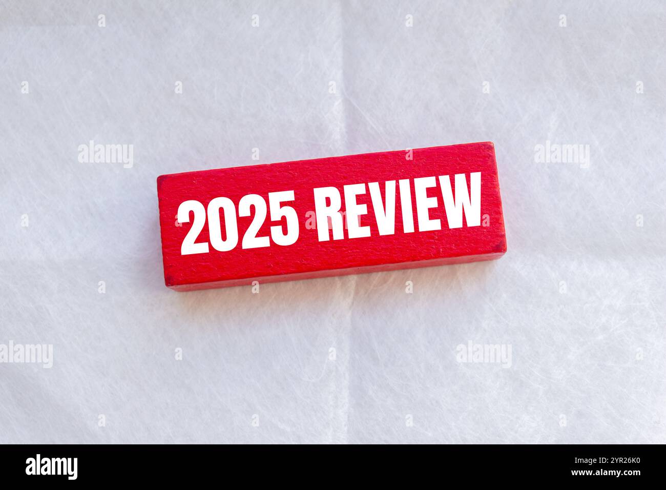 2025 review message written on wooden red block with white background. Conceptual 2025 review ...