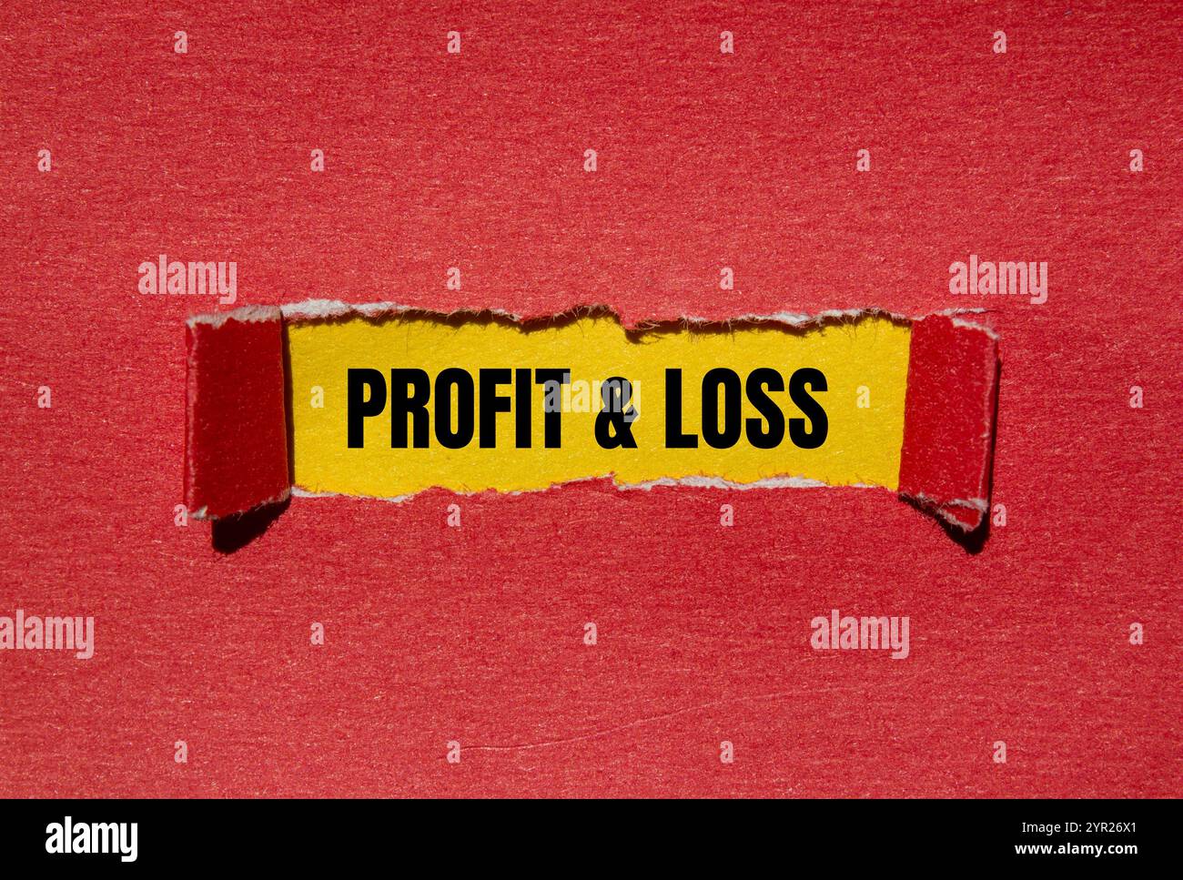 Profit and loss message written on ripped torn red paper with yellow ...