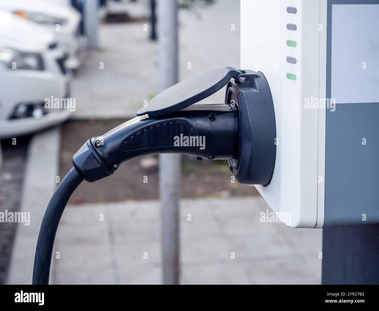 EV car charger handle plugged in, electric vehicle charging cable ...
