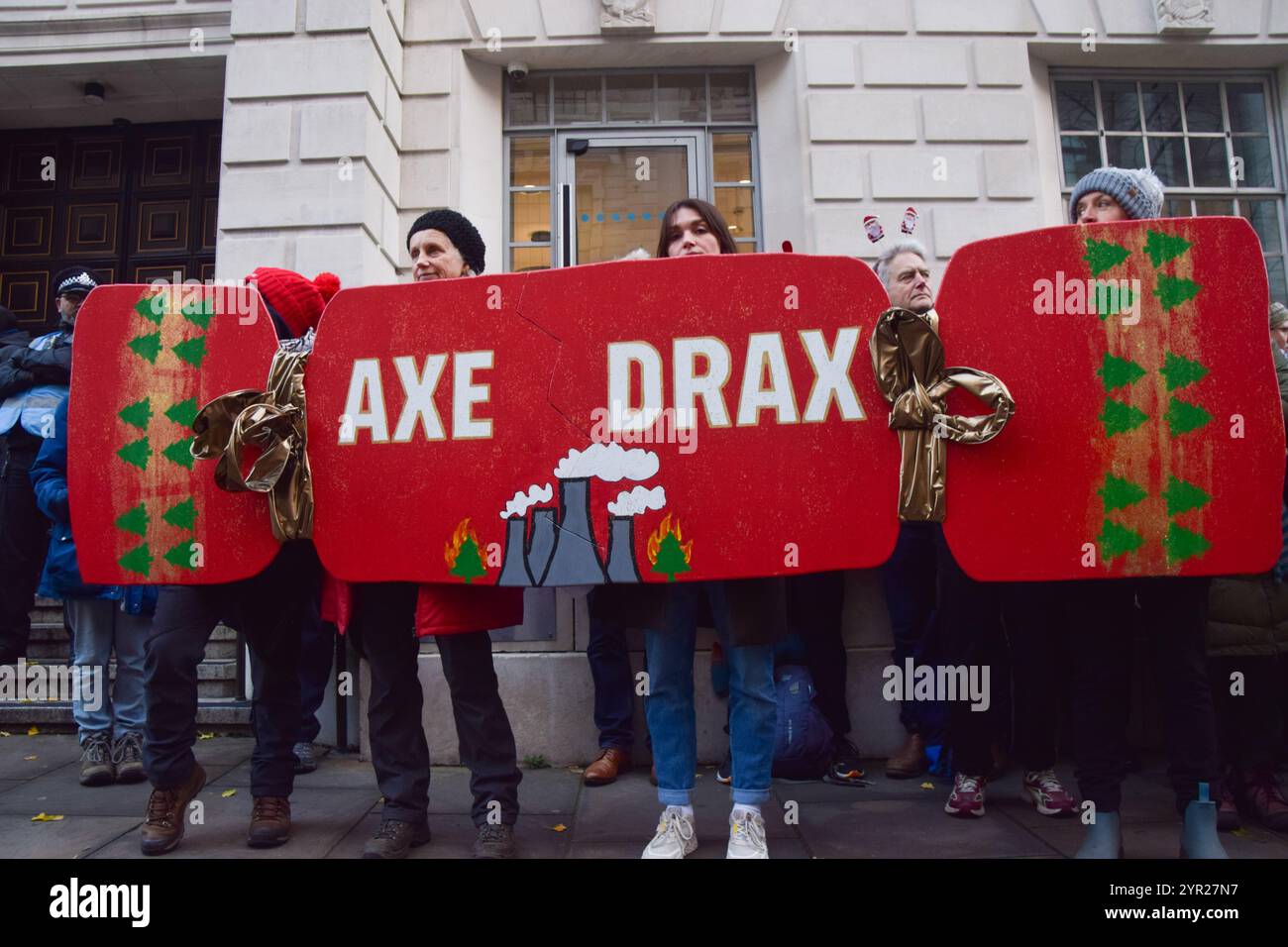 London, UK. 2nd December 2024. Protesters hold a Christmas-cracker ...