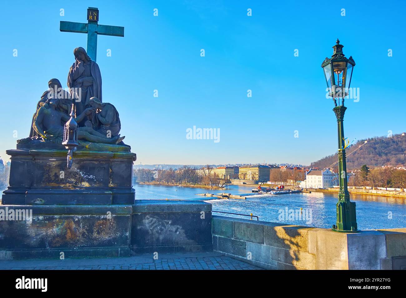 The medieval stone Pieta statue on the Charles Bridge against the ...