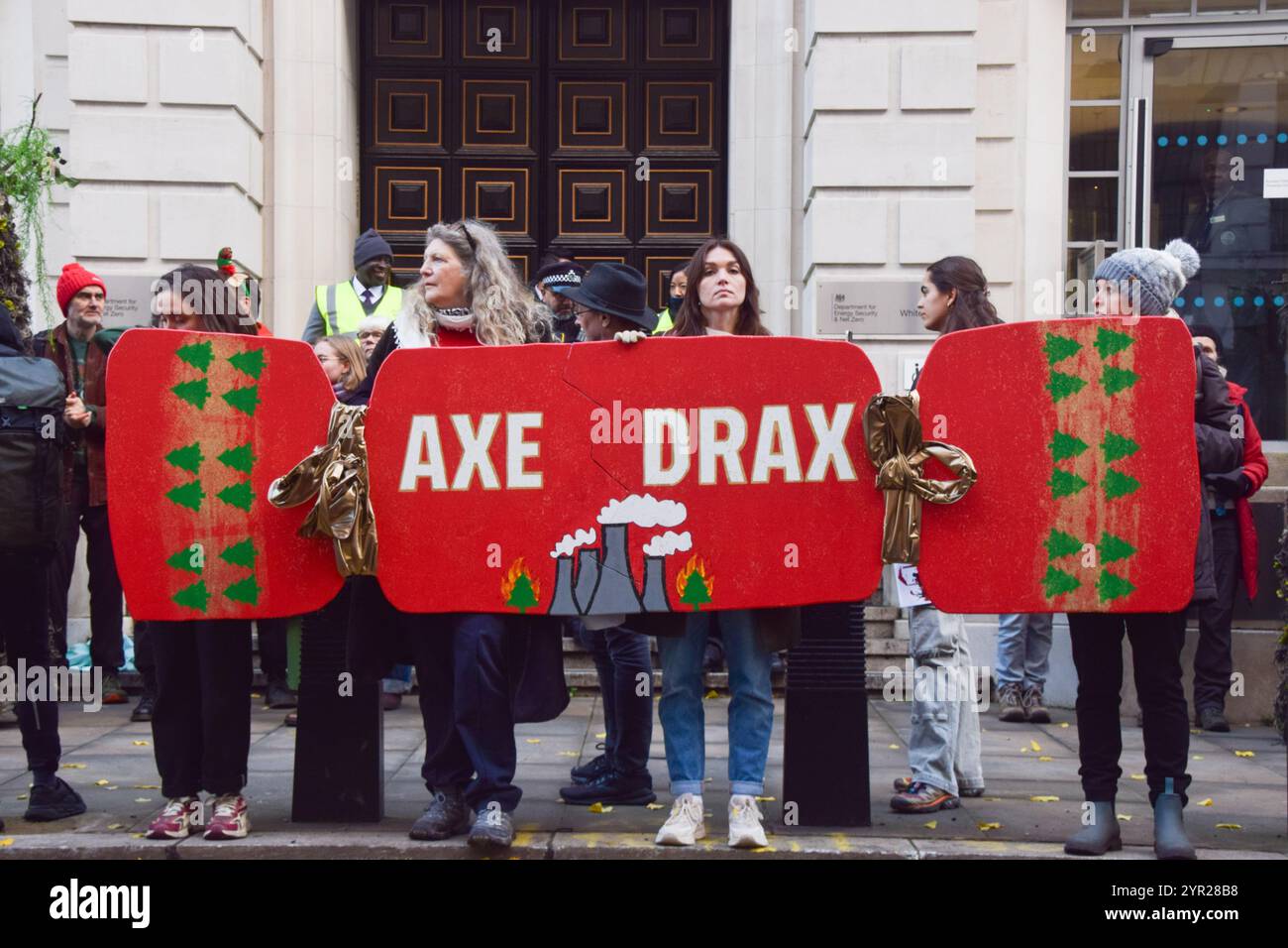 London, UK. 2nd December 2024. Protesters hold a Christmas-cracker ...