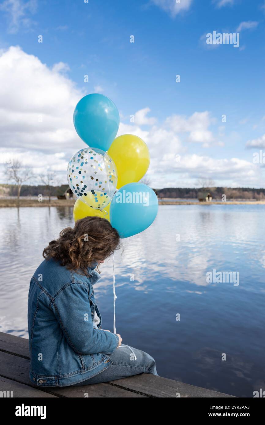 Woman Sitting On Balloons Girl Holding Balloons Sitting On Hi Res