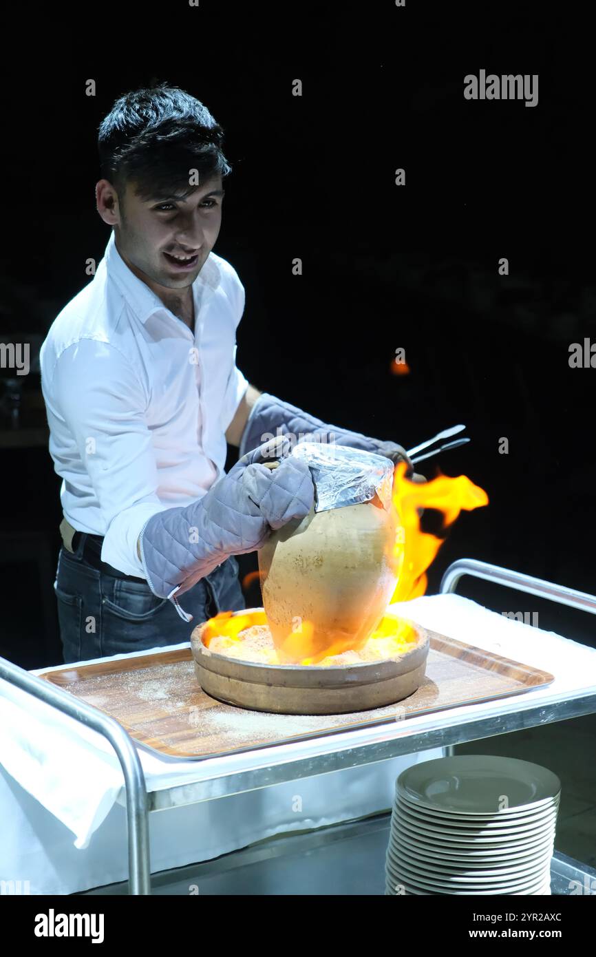 Turkish chef cooking Testi Kebab (Pottery Kebab). Traditional Turkish ...