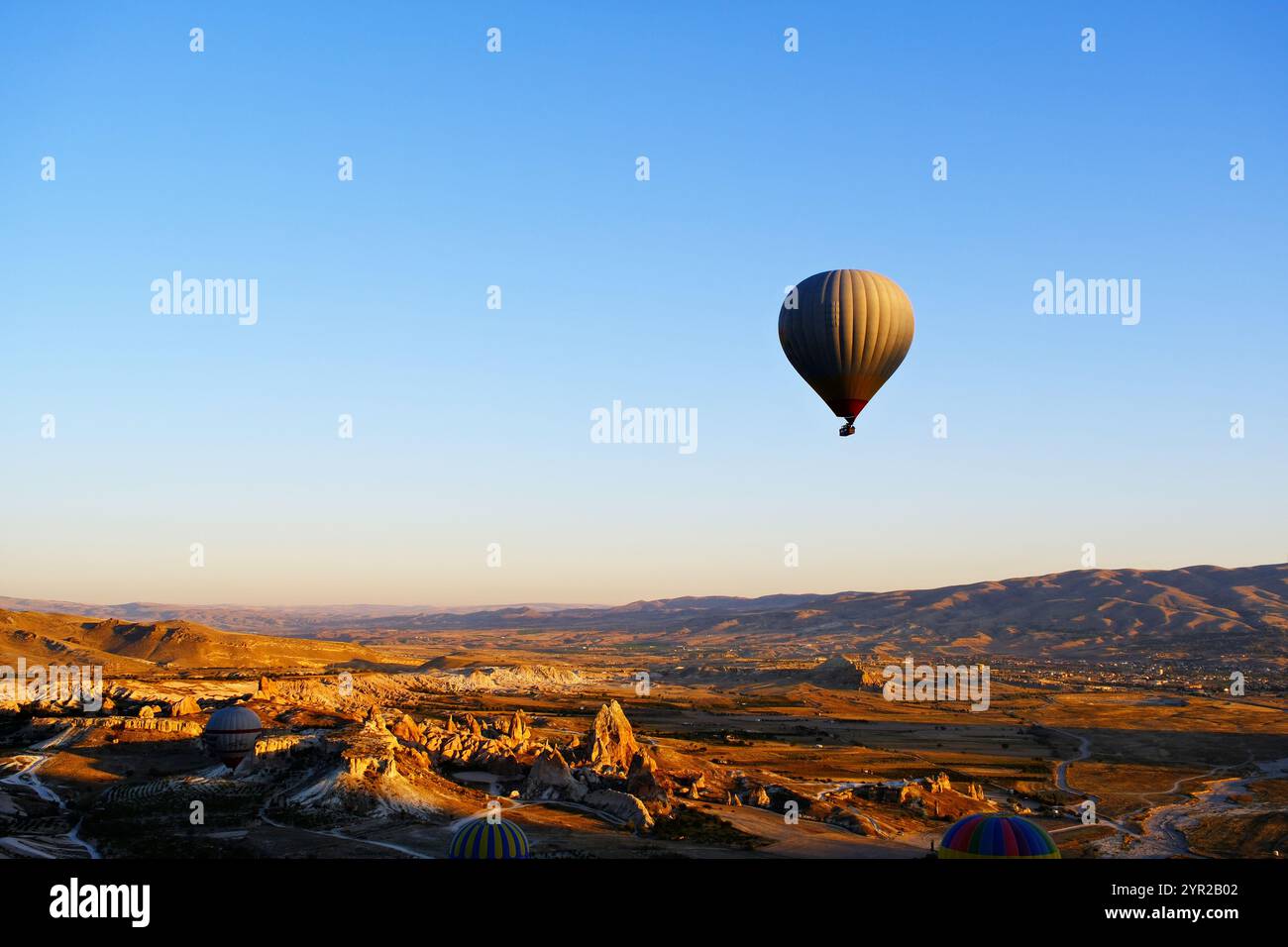 one hot air balloon fly in sky and landscape of Cappadocia, Turkey at ...