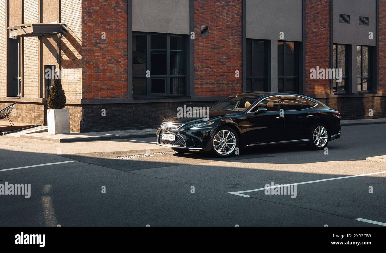 Lexus LS sedan in downtown. Front three quarter view of executive car ...