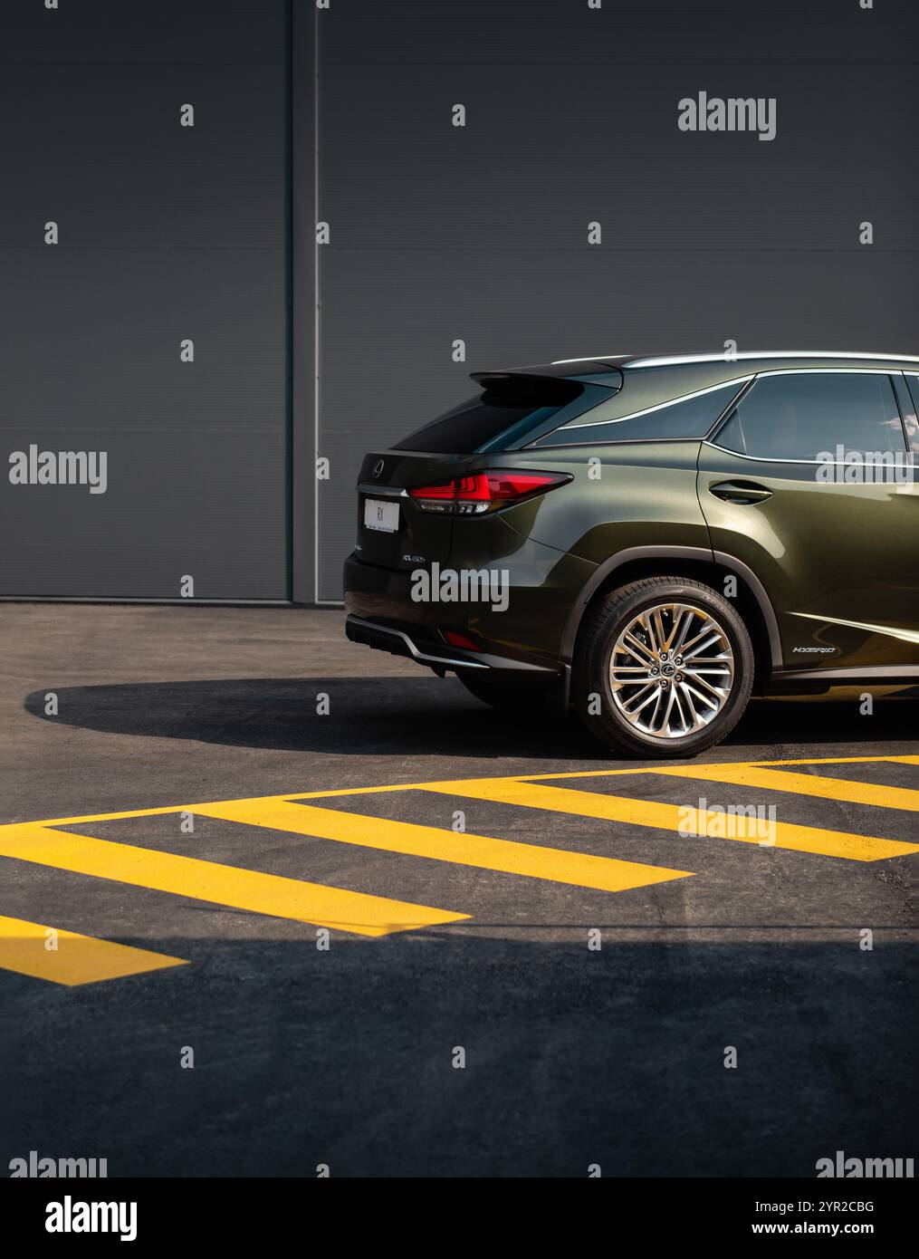 Rear of green Lexus RX in parking lot. Side view of rear part of ...