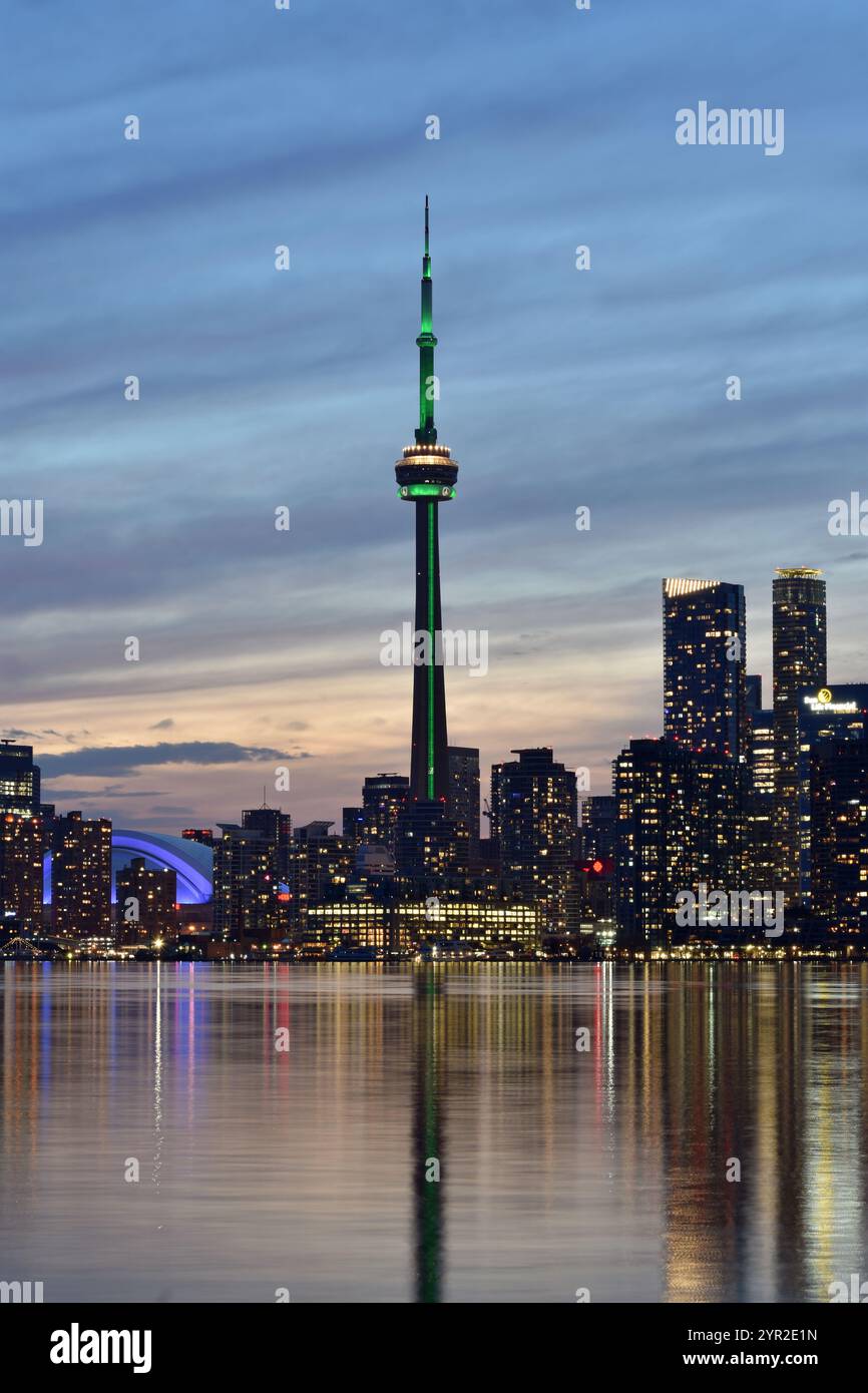 A colourful sunset behind the downtown Toronto city skyline and CN ...