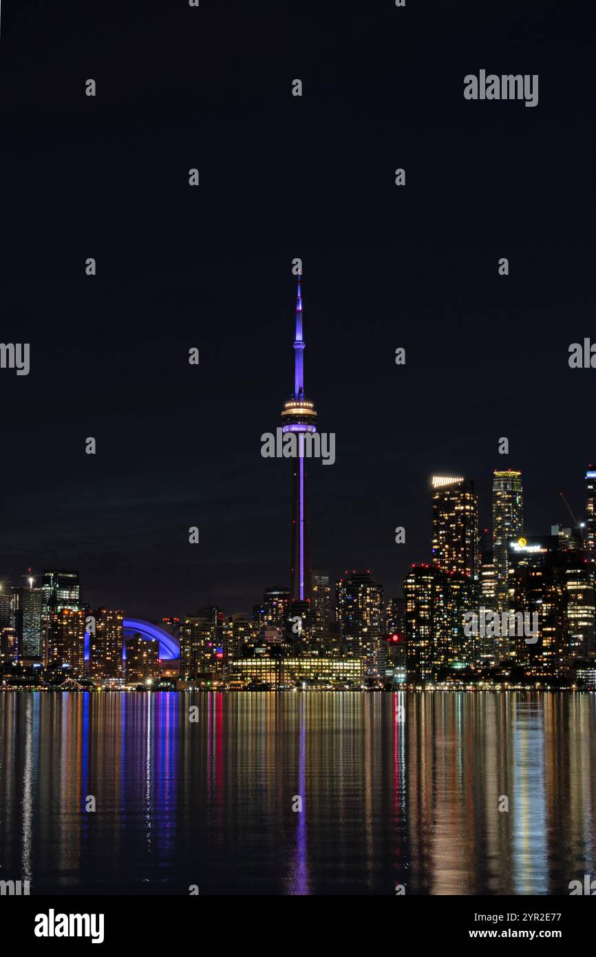 Downtown Toronto illuminated at night. Lights reflected in Lake Ontario ...