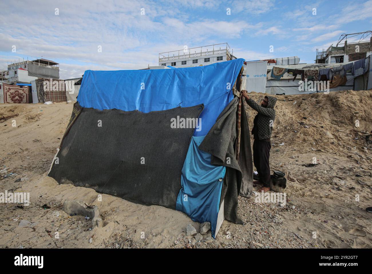 Odai Olaiwa and his family are pictured beside a tent on the seaside in ...