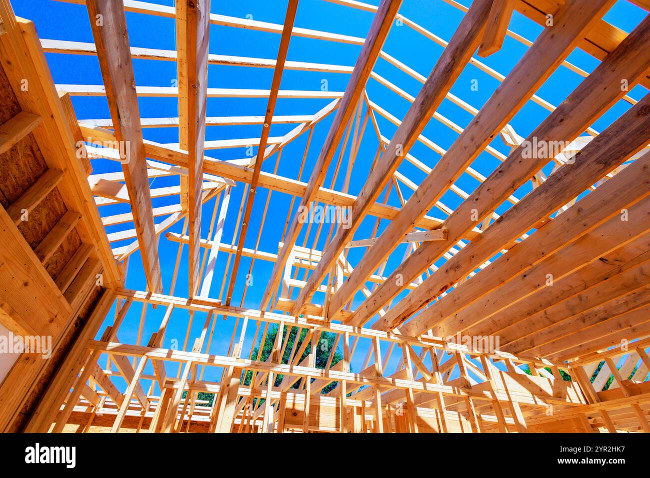 An open roof structure of wooden beams with progressing structural ... An open roof structure of wooden beams with progressing structural ...