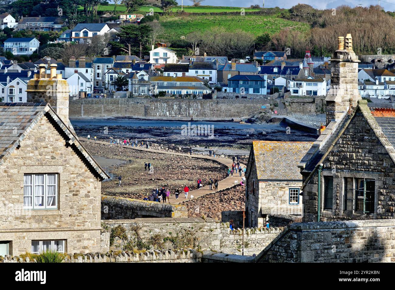 People crossing the tidal causeway at low tide, St Michaels Mount with ...