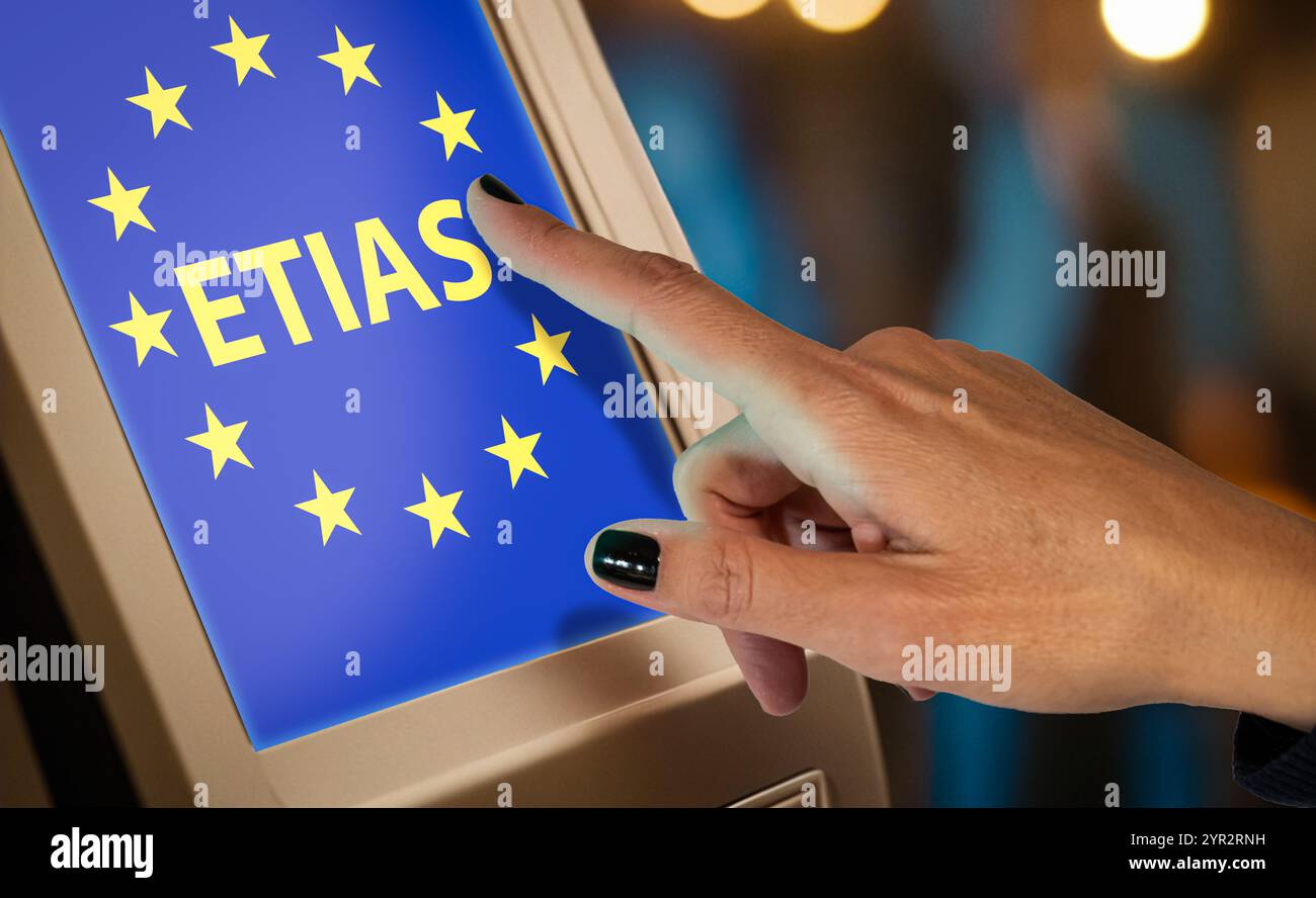 Hand using ETIAS application screen interface. European Travel Information and Authorization ...