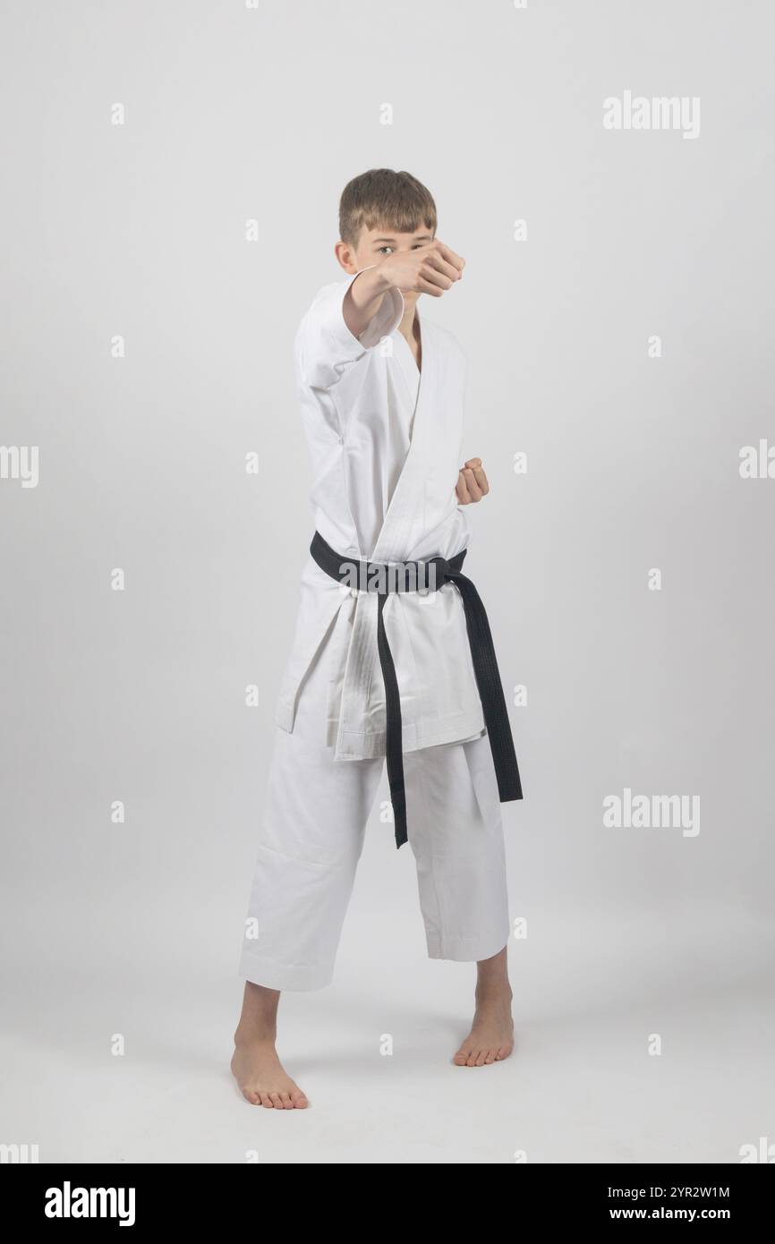 Fifteen year old male teenage karate black bel in sanchin stance doing ...