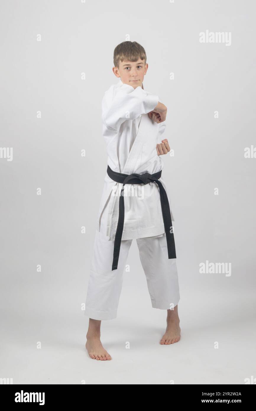 Fifteen year old male teenage karate black bel in sanchin stance doing ...