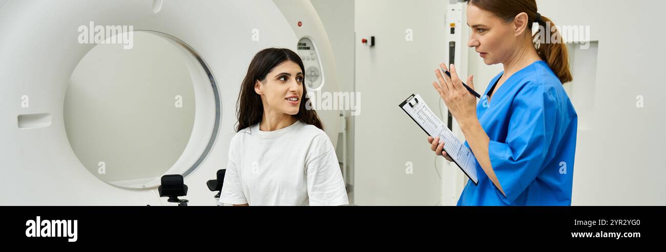 A female doctor reassures her patient ahead of an MRI scan in a ...