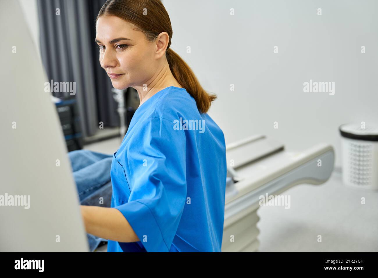 A dedicated female doctor oversees a patient undergoing an MRI scan in ...