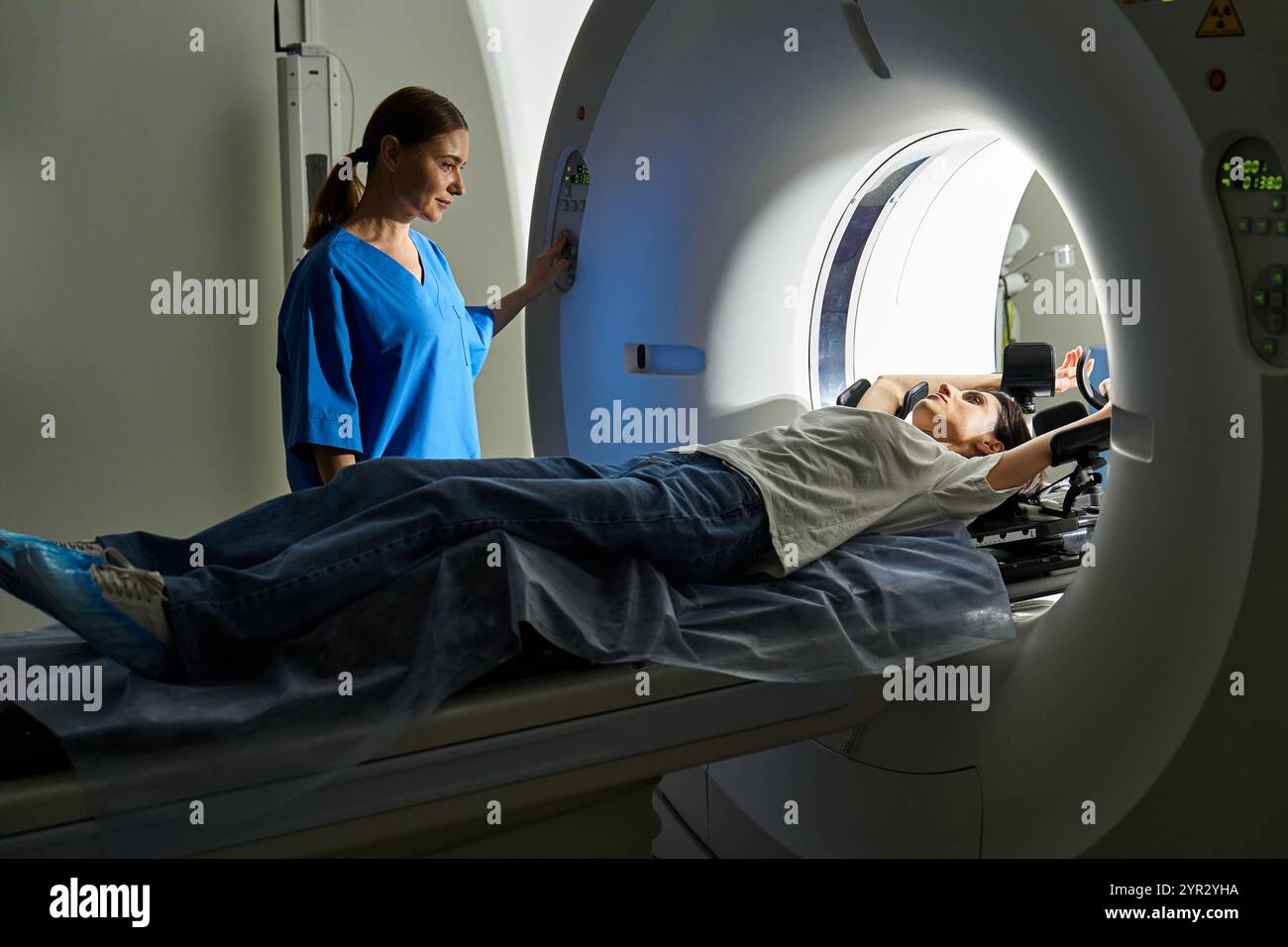 A dedicated female doctor guides a patient through a diagnostic MRI ...